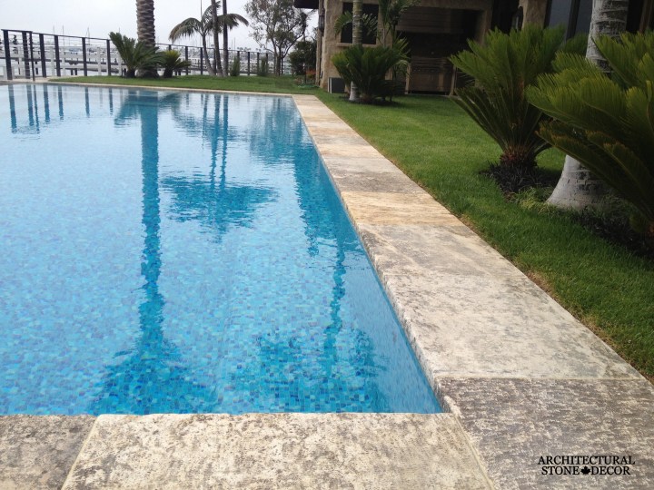 Treat your outdoor pool with antique limestone pool coping.